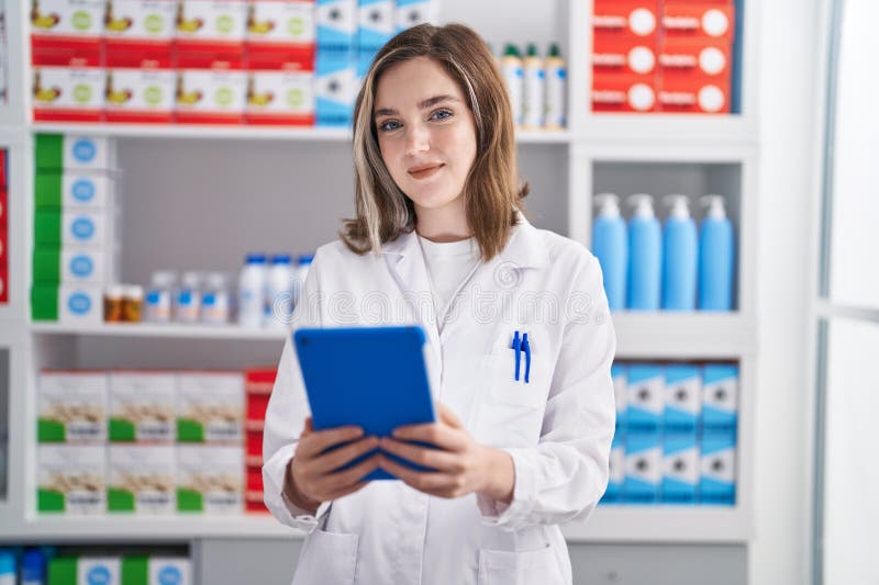 Young Woman Pharmacist Using Touchpad at Pharmacy Stock Image - Image ...