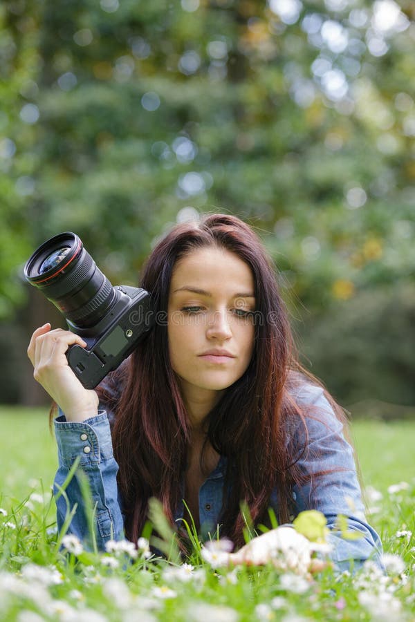 Young Woman Photographer with Camera Lie Down on Grass Stock Image ... Young Woman Photographer with Camera Lie Down on Grass Stock Image ...