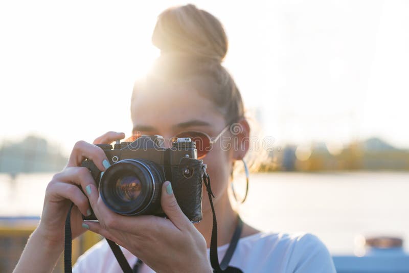Young Woman Photographer Using a Camera in Bright Daylight Stock Image ...