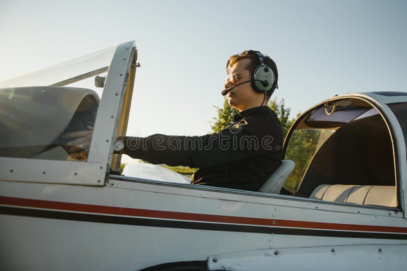 Young Woman and Pilot in in the Cockpit of a Plane. Front View Stock ...