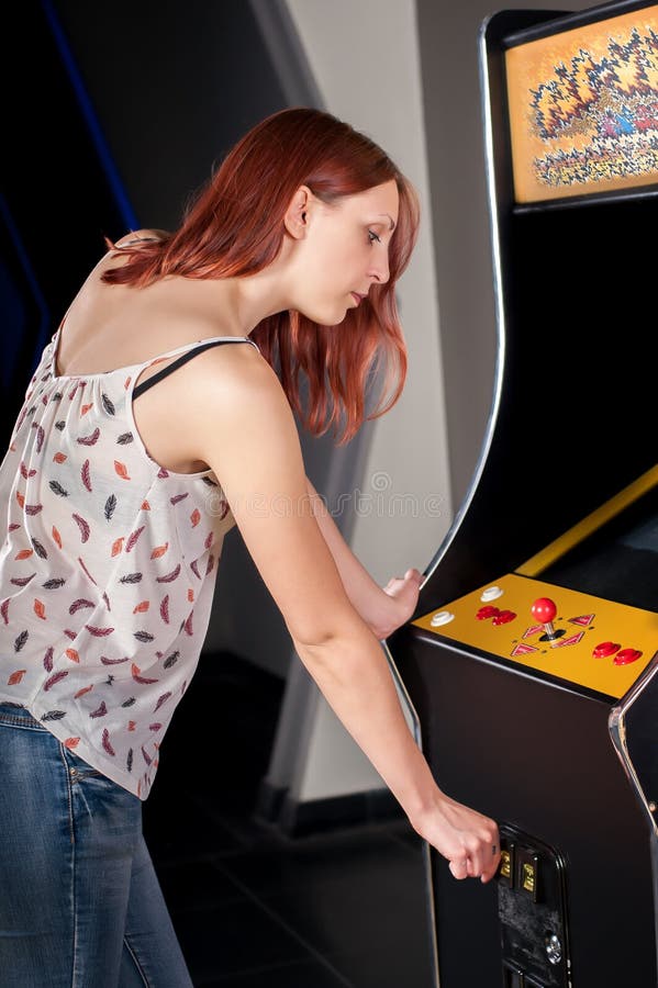 Young woman playing arcade stock image. Image of equipment - 78438393