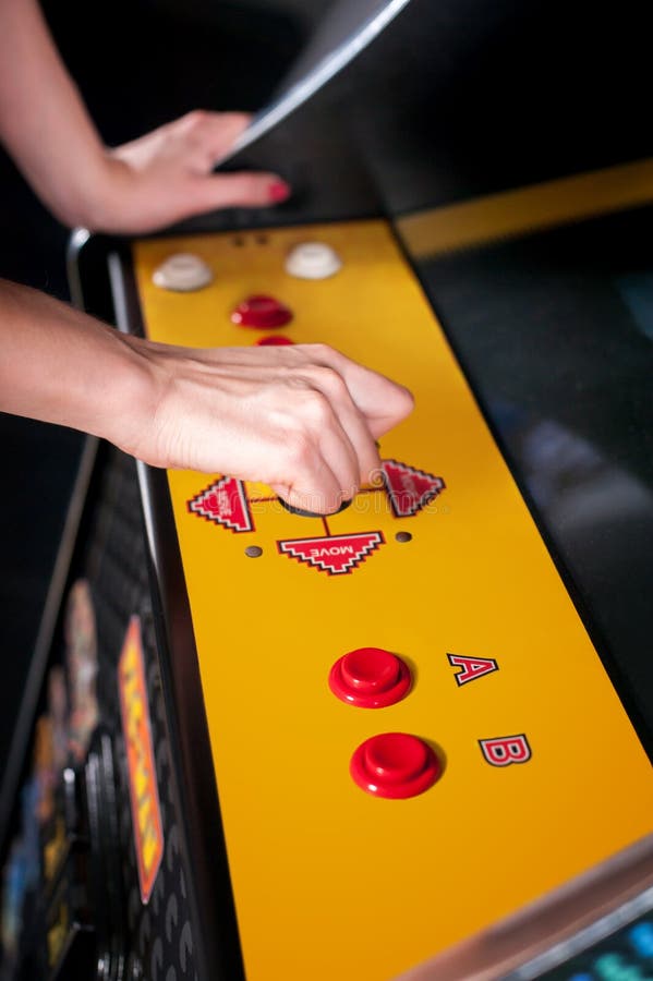 Young woman playing arcade stock image. Image of finger - 78438935