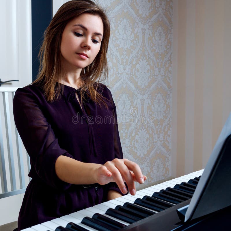 Young Woman Playing on the Electronic Piano at Home. Stock Photo ...