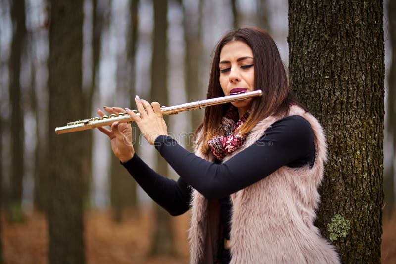 Young Woman Playing Flute Outdoor Stock Image - Image of caucasian ...