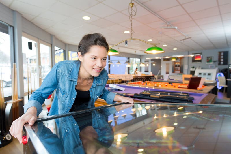 Young Woman Playing on Pinball Machine in Game Room Stock Image - Image ...