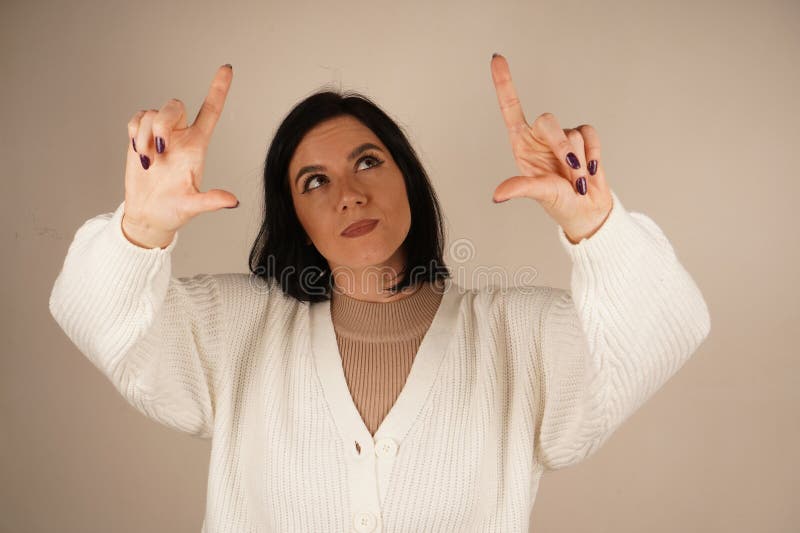 The Young Woman Points in One Direction with Both Index Fingers ...