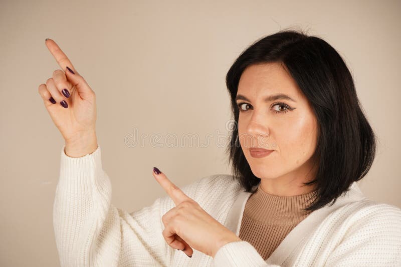 The Young Woman Points in One Direction with Both Index Fingers ...