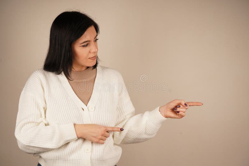The Young Woman Points in One Direction with Both Index Fingers ...