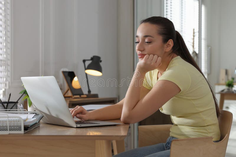 Young Woman with Poor Posture Using Laptop at Table Indoors Stock Photo ...