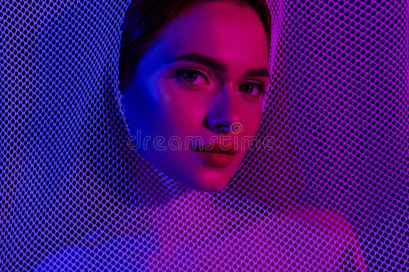 Vibrant Portrait of a Young Woman with Artistic Neon Lighting and Mesh ...