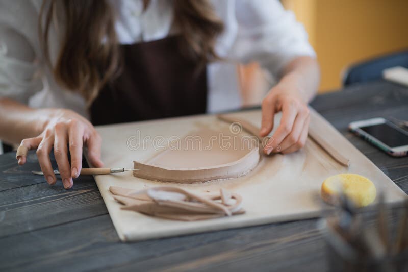 Young Woman on a Pottery Class Working with Different Tools. Stock ...