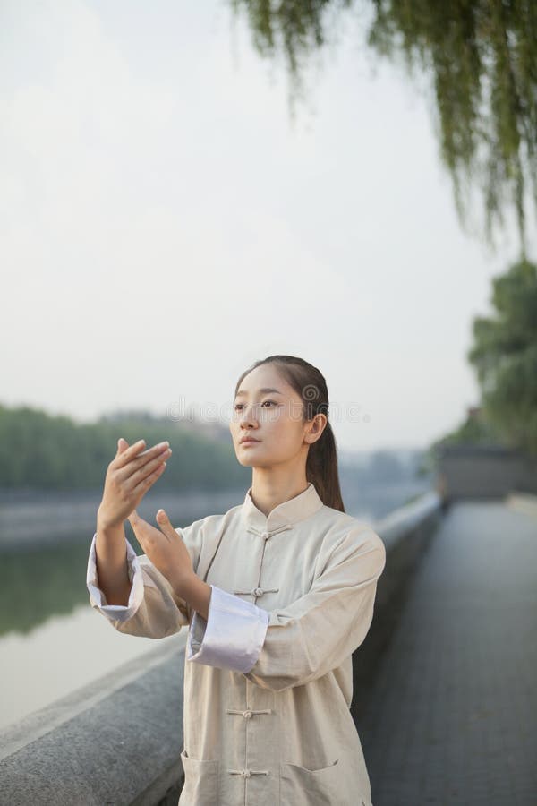 Young Woman Practicing Tai Ji, Arms Out Front, by the Canal Stock Image ...