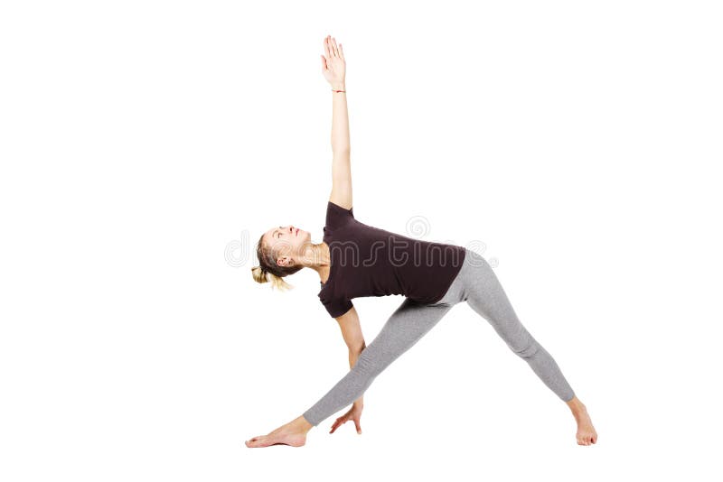 Young Woman Practicing Yoga,standing in an Exercise Leaning Forward To ... Young Woman Practicing Yoga,standing in an Exercise Leaning Forward To ...