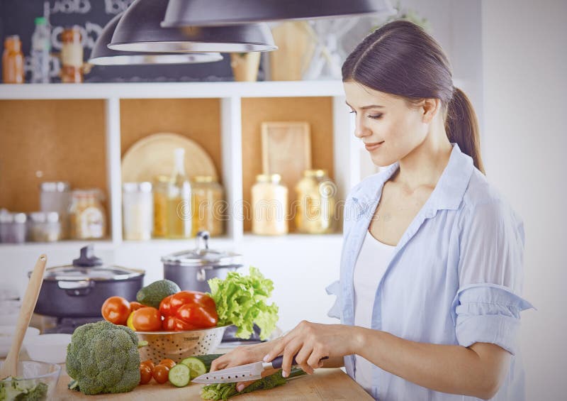 A Young Woman Prepares Food In The Kitchen Healthy Food Vege Stock