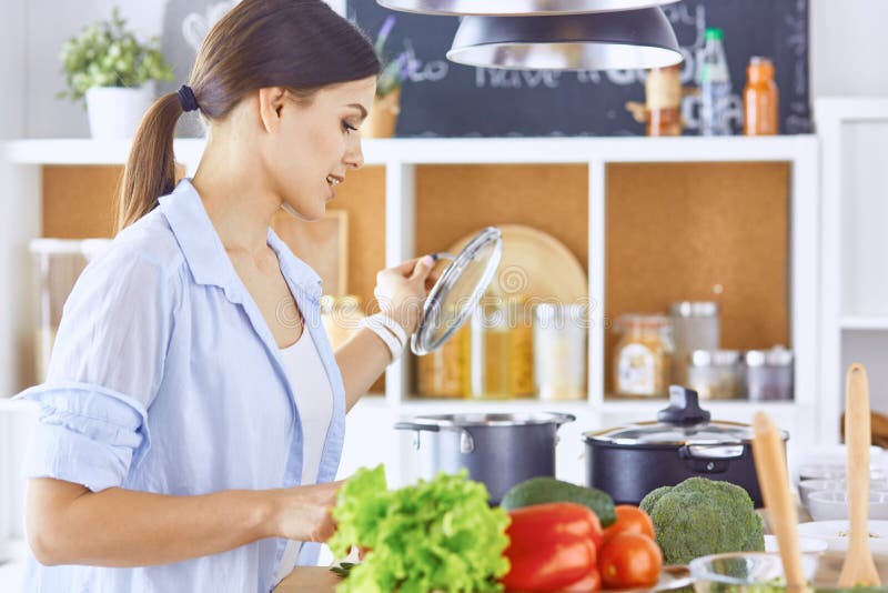A Young Woman Prepares Food In The Kitchen Healthy Food Vege Stock
