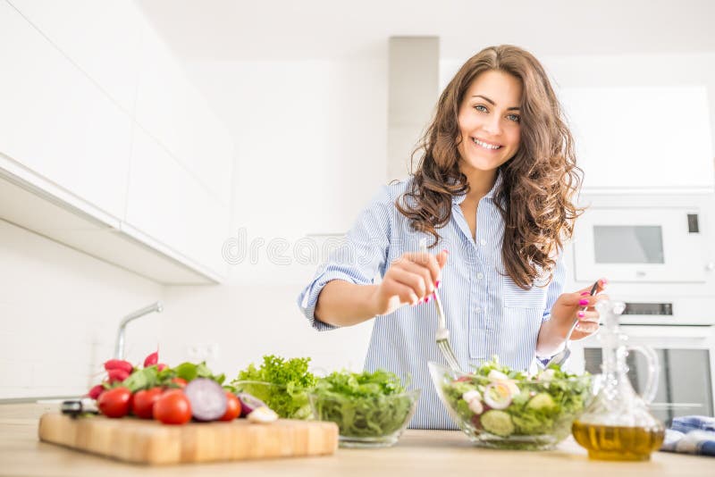 Young Woman Preparing Vegetable Salad In Her Kitchen Healthy Lifestyle