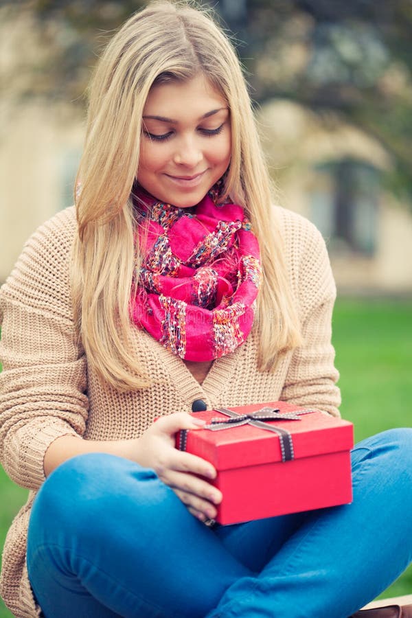Young Woman with Present on Bench Stock Image - Image of female, face ...