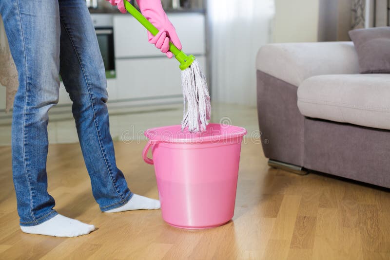 Woman In Protective Gloves Using A Wet Mop While Cleaning Floor Stock