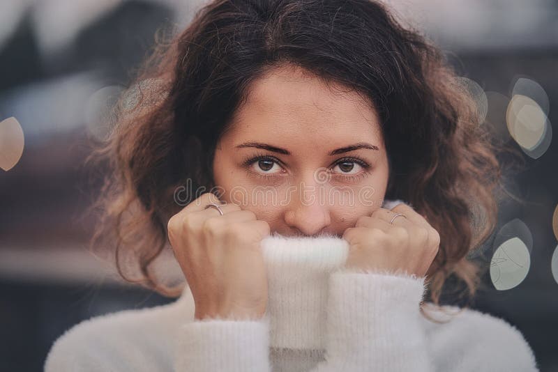 Young Woman Pulling Her White Sweater Over Head Stock Photo - Image of ...