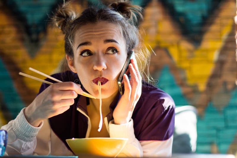 Young Woman Pulls Macaroni and Talks on the Phone Stock Image - Image ...