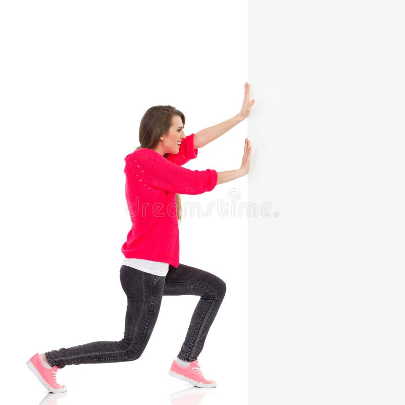 Young Woman Pushing the Wall Stock Photo - Image of attractive, casual ...