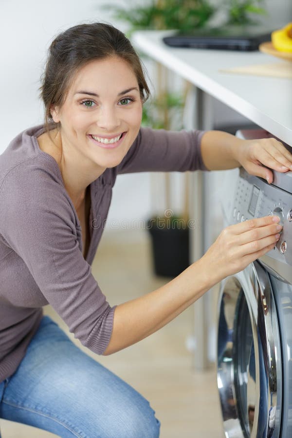 Young Woman Putting Laundry into Washing Machine Stock Photo - Image of ...