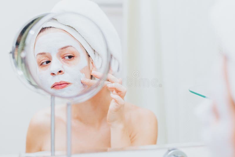 Young Woman Putting a Mask on Her Face Stock Image - Image of ...