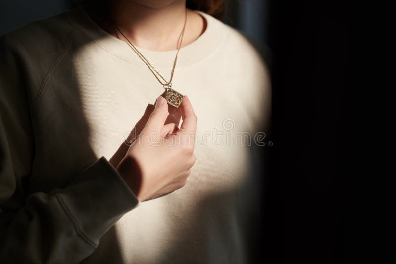 Woman Putting on Pedant stock photo. Image of present - 270724004