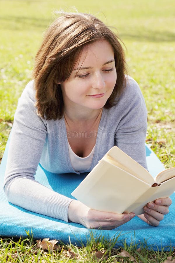 Young woman reading book stock photo. Image of young - 19390860