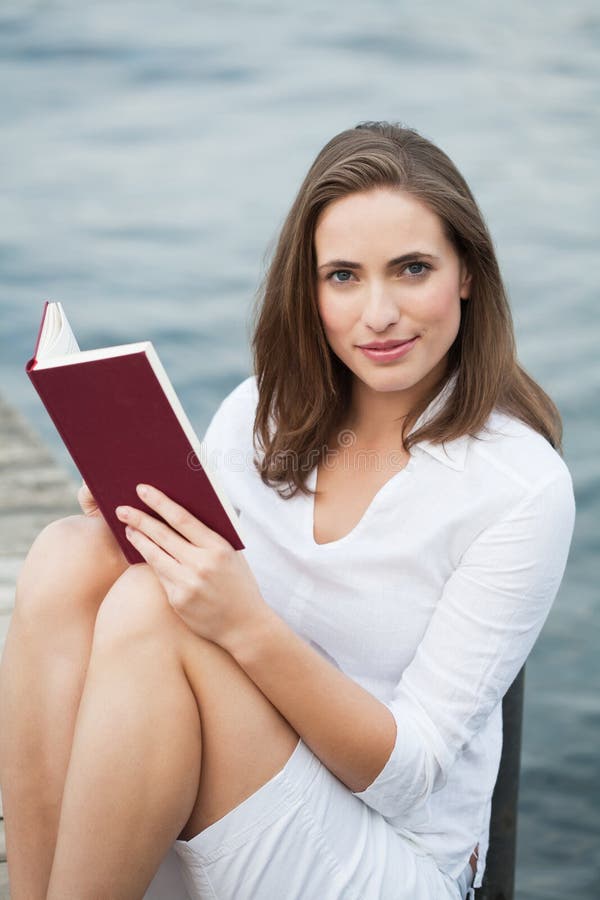 Young woman reading a book stock image. Image of post - 21347095