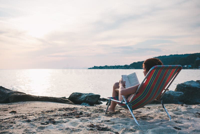 Young Woman Reading a Book on the Beach Stock Image - Image of sand ...