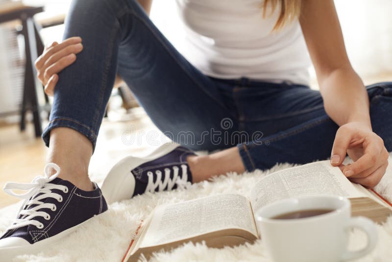 Young Woman Reading Book on Carpet Stock Photo - Image of student ...
