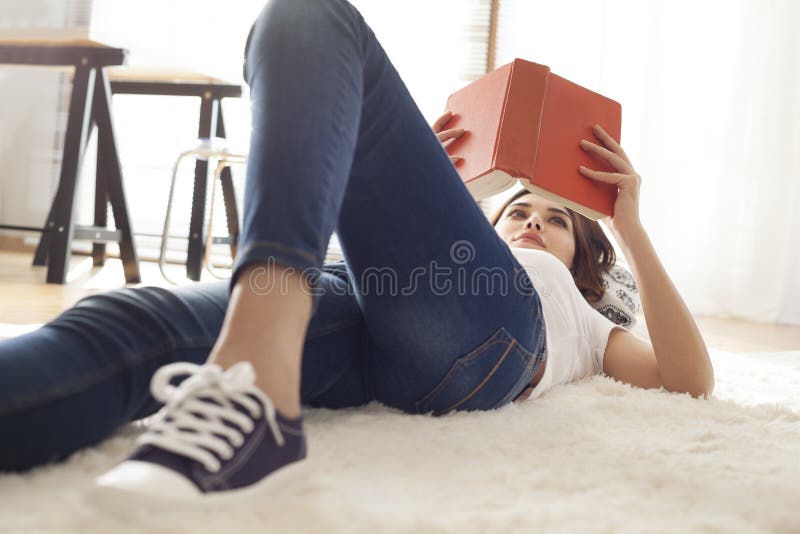 Young Woman Reading Book on Carpet Stock Image - Image of novel ...