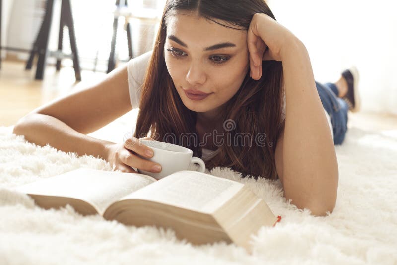 Young Woman Reading Book on Carpet Stock Photo - Image of inside, room ...