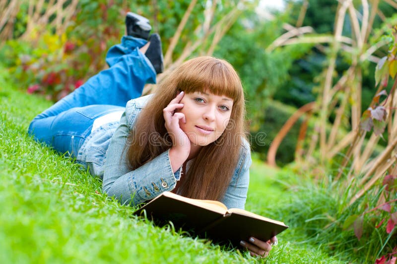 Young Woman Reading A Book Lying On The Grass Stock Image Image Of