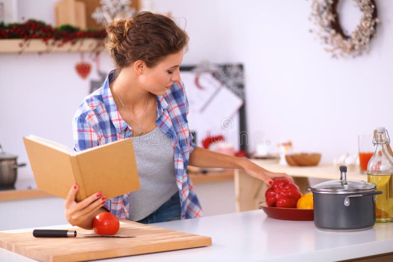 Young Woman Reading Cookbook in the Kitchen Stock Photo - Image of ...
