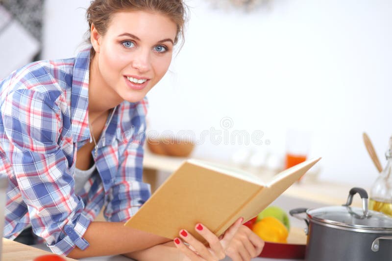 Young Woman Reading Cookbook in the Kitchen, Stock Photo - Image of ...