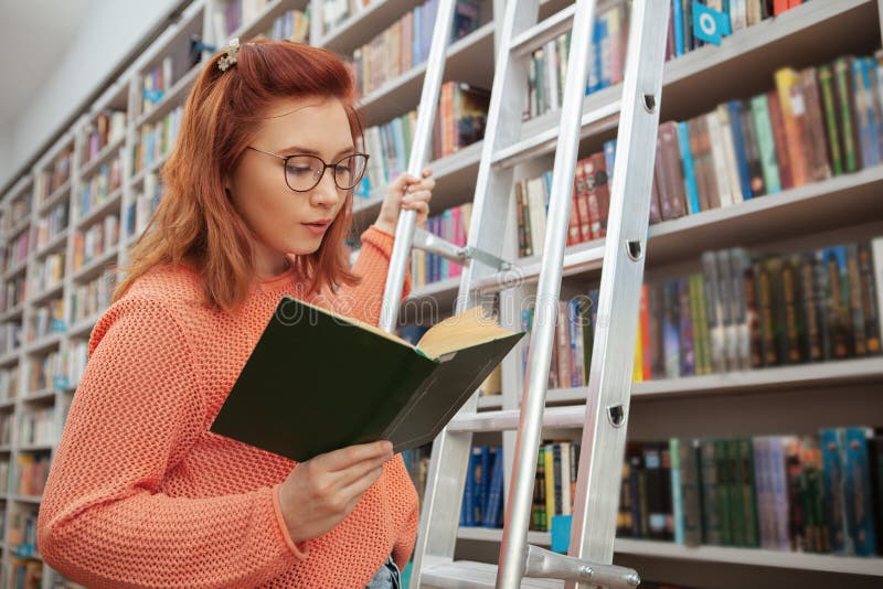 Young Woman Reading at the Library Stock Photo - Image of indoor ...
