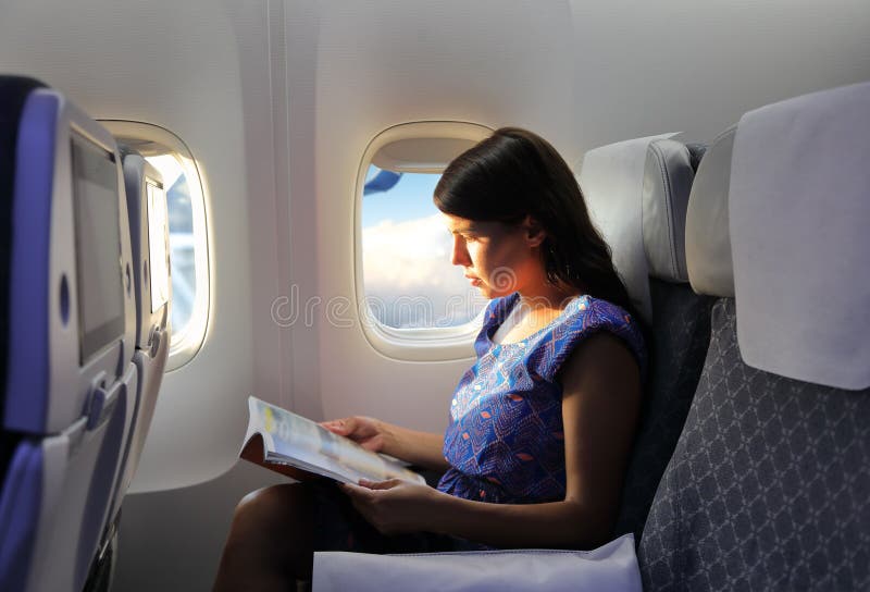 Young Woman Reading Magazine during the Flight Stock Image - Image of ...