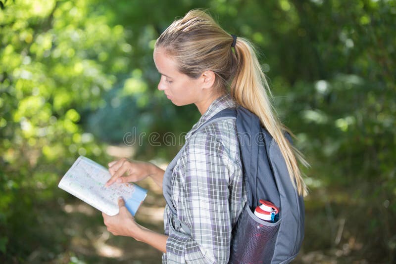 Young woman reading map stock image. Image of young - 100303661