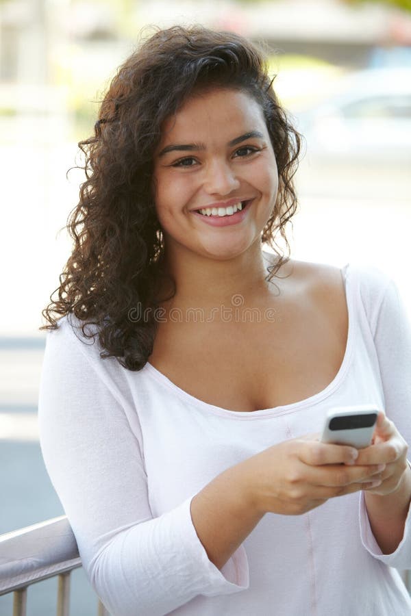 Young Woman Reading Text Message in Urban Setting Stock Image - Image ...