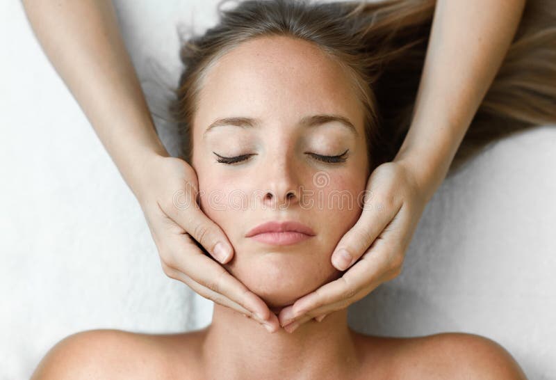 Young Woman Receiving A Head Massage In A Spa Center Stock Image
