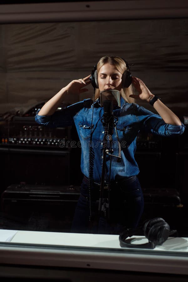 Young Woman in Recording Studio Talking into Microphone. Stock Photo ...
