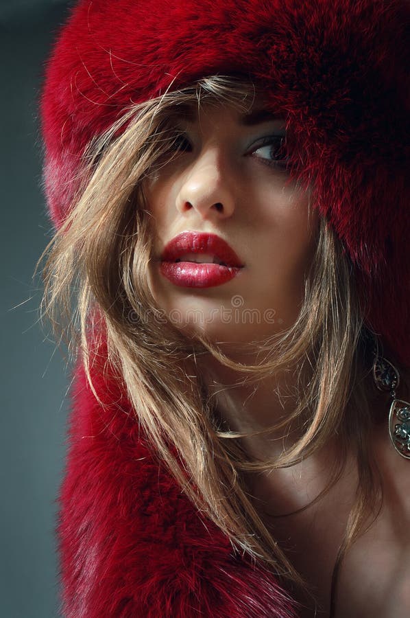 Young woman in red fur hat stock image. Image of studio - 20379689