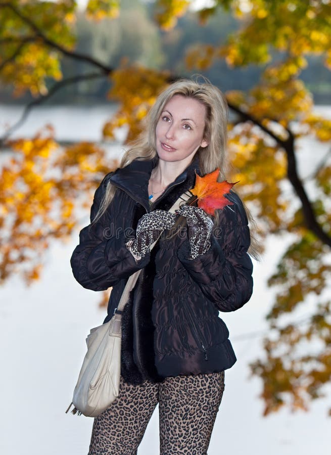 The Young Woman with a Red Leaf of a Tree Stock Photo - Image of ...
