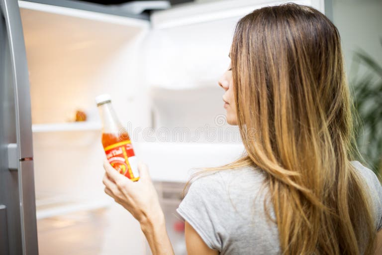 Young Woman by the Refrigerator Stock Photo - Image of interior ...