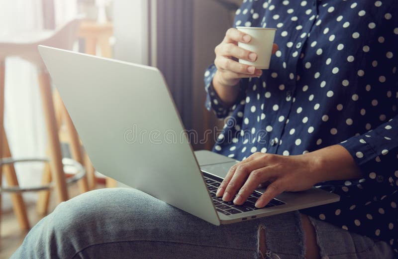 Young Woman Relaxing and Drinking Cup of Hot Coffee or Tea Using Laptop ...