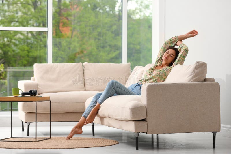 Young Woman Relaxing on Sofa Stock Image - Image of couch, break: 221288491