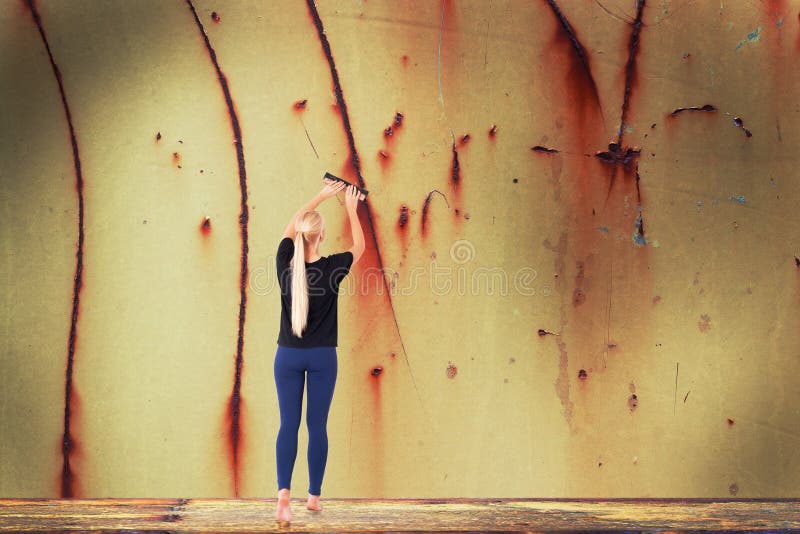 Young Woman Removes Rust from Wall Stock Photo - Image of interior ...