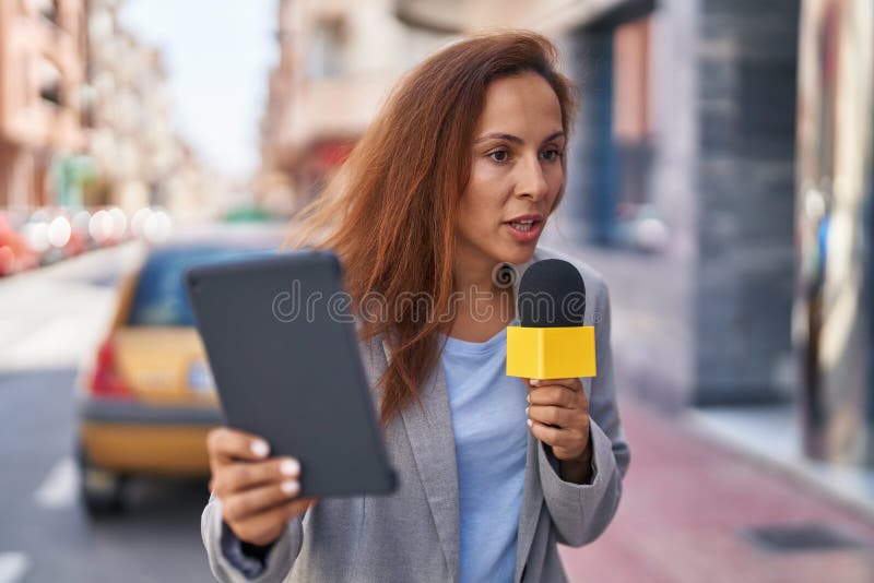 Young Woman Reporter Working Using Microphone and Touchpad at Street ...